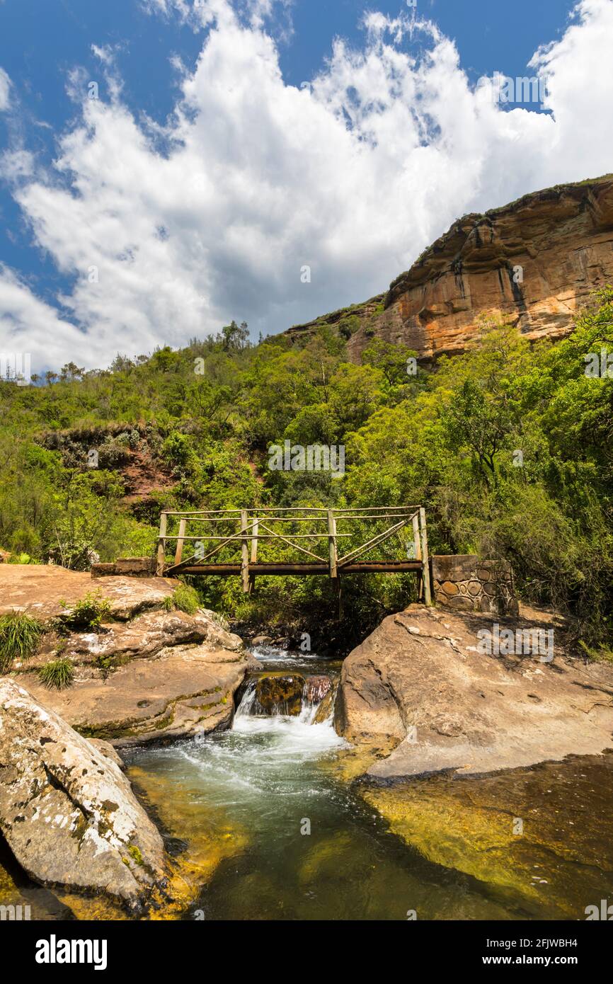 Pedestrian bridge over small waterfall in the mountain Stock Photo - Alamy