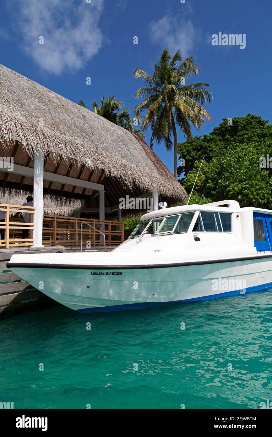 Boat at the jetty at Bandos Island in the Maldives. The Maldives is a ...