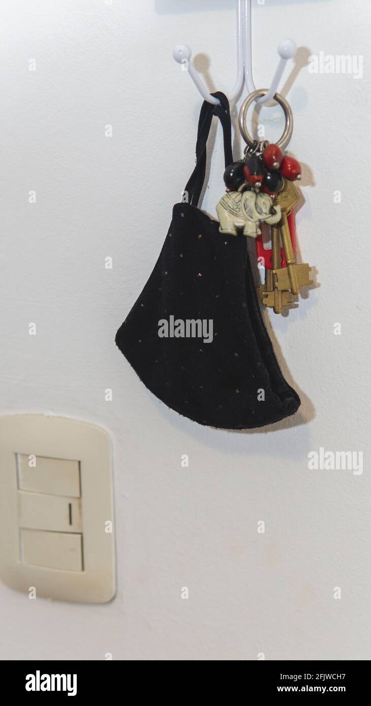 new normal concept. Face mask hanging from a hook next to the house ...