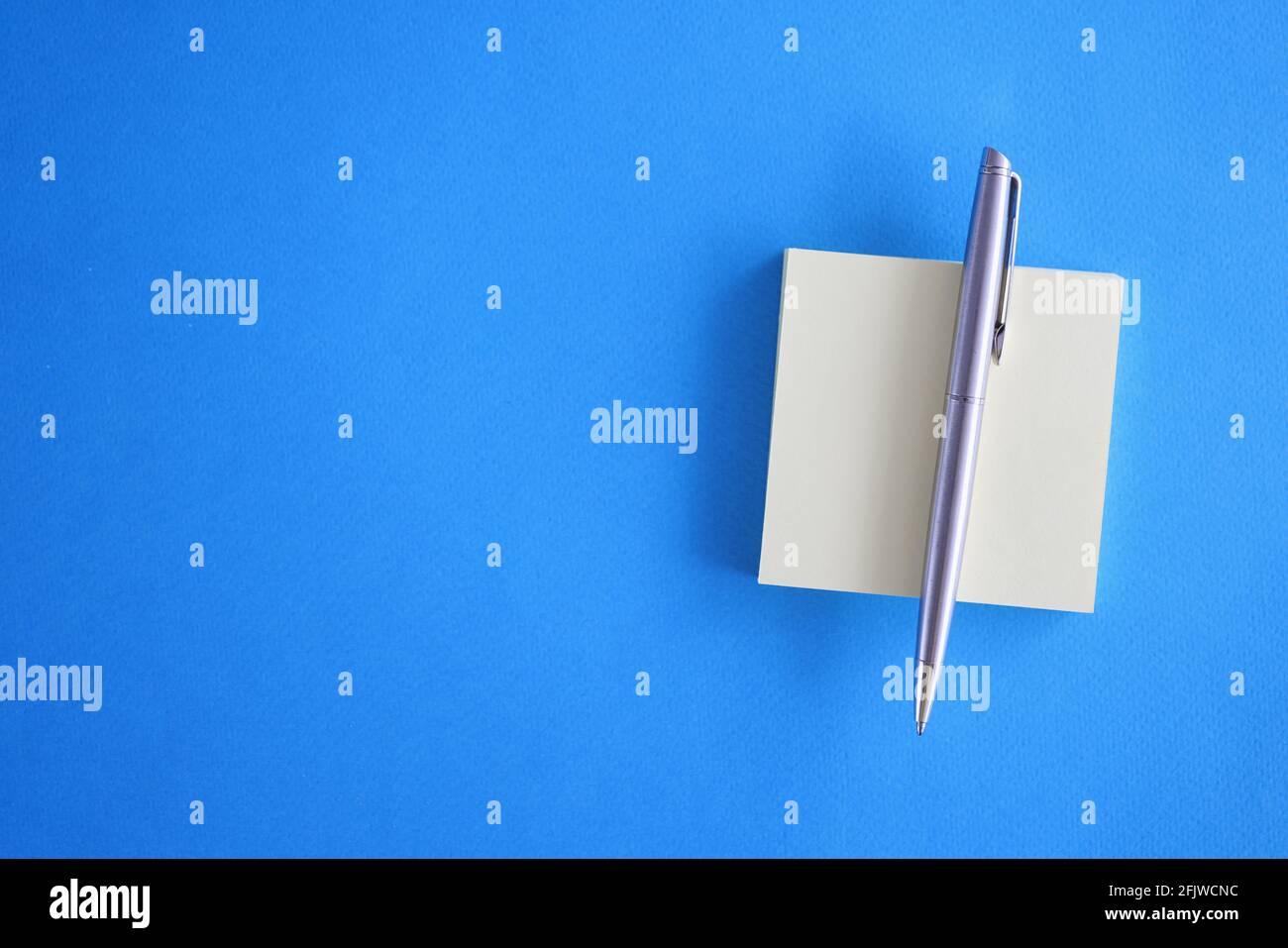 White sticky notes with pen on light blue background Stock Photo - Alamy
