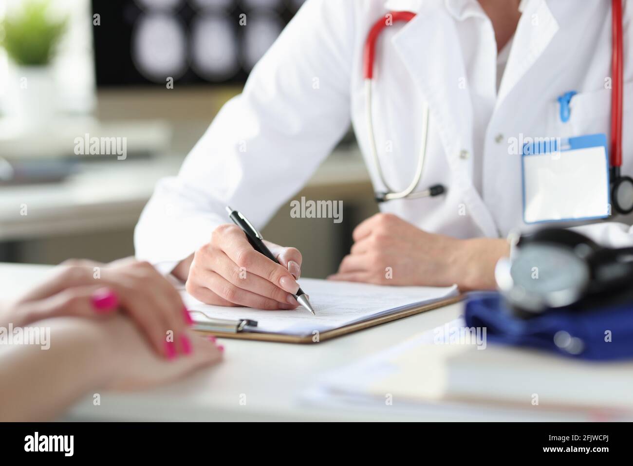 Hands of doctor writing in a patient medical card Stock Photo - Alamy