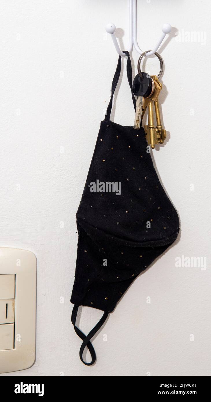 new normal concept. Face mask hanging from a hook next to the house ...