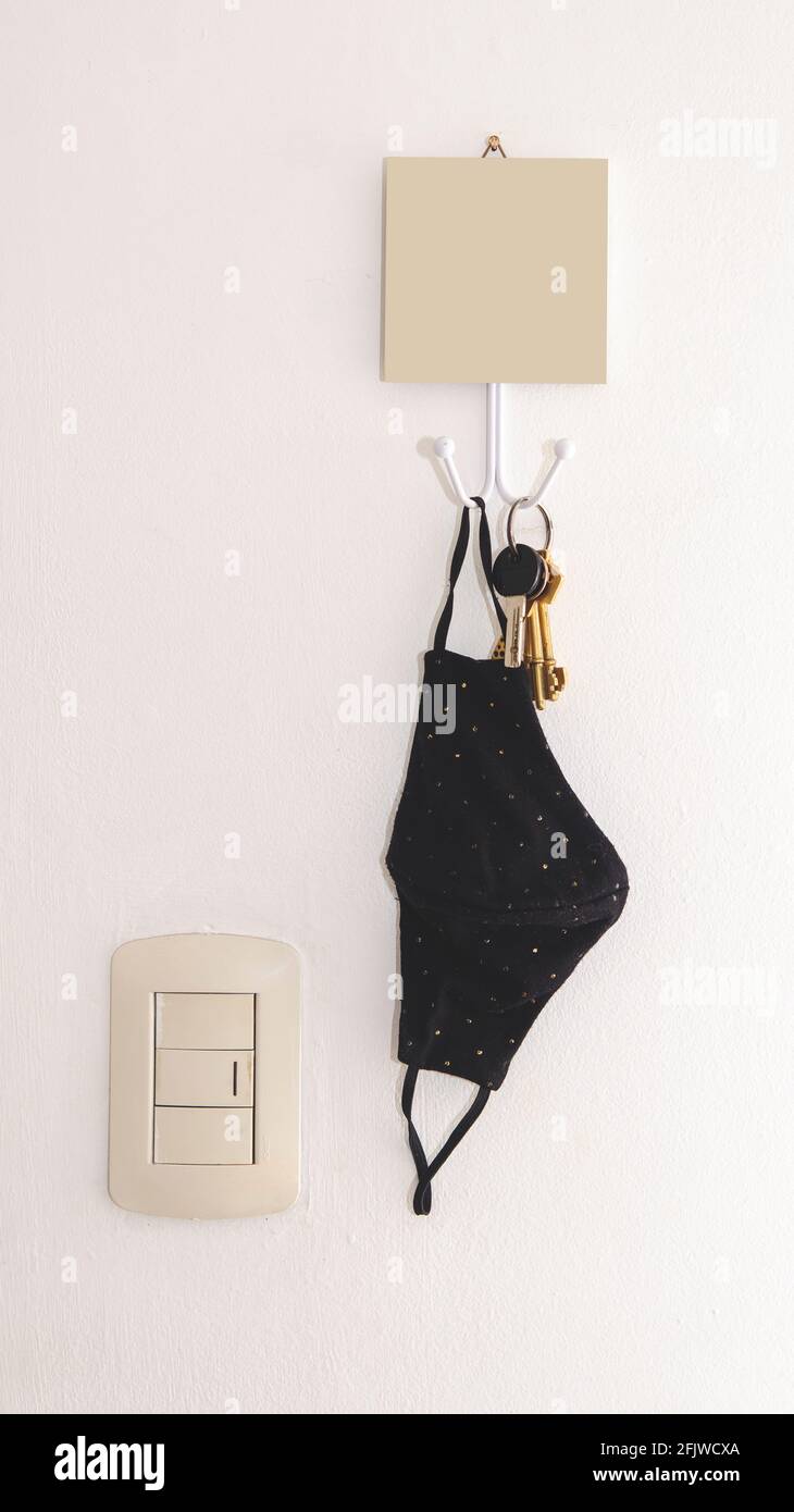 new normal concept. Face mask hanging from a hook next to the house ...