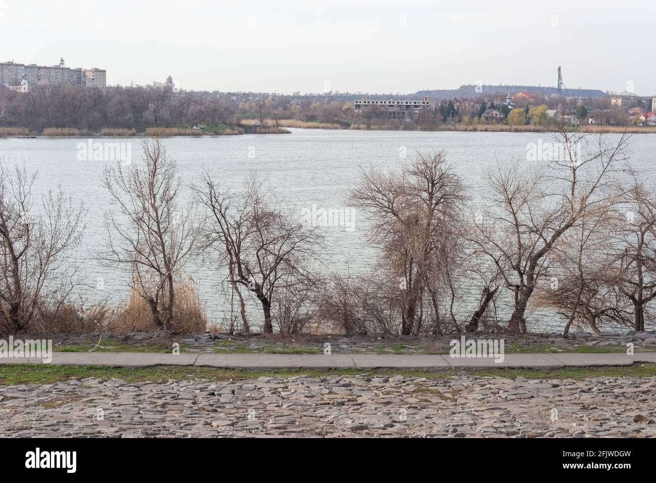 daytime city river landscape with trees and houses Stock Photo - Alamy