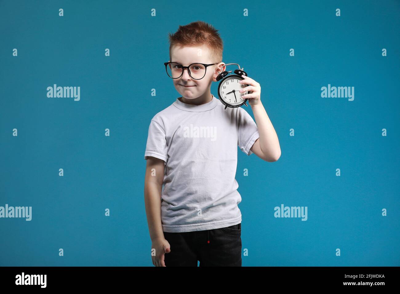 Time management. Morning. little boy with alarm clock. Happy childhood ...