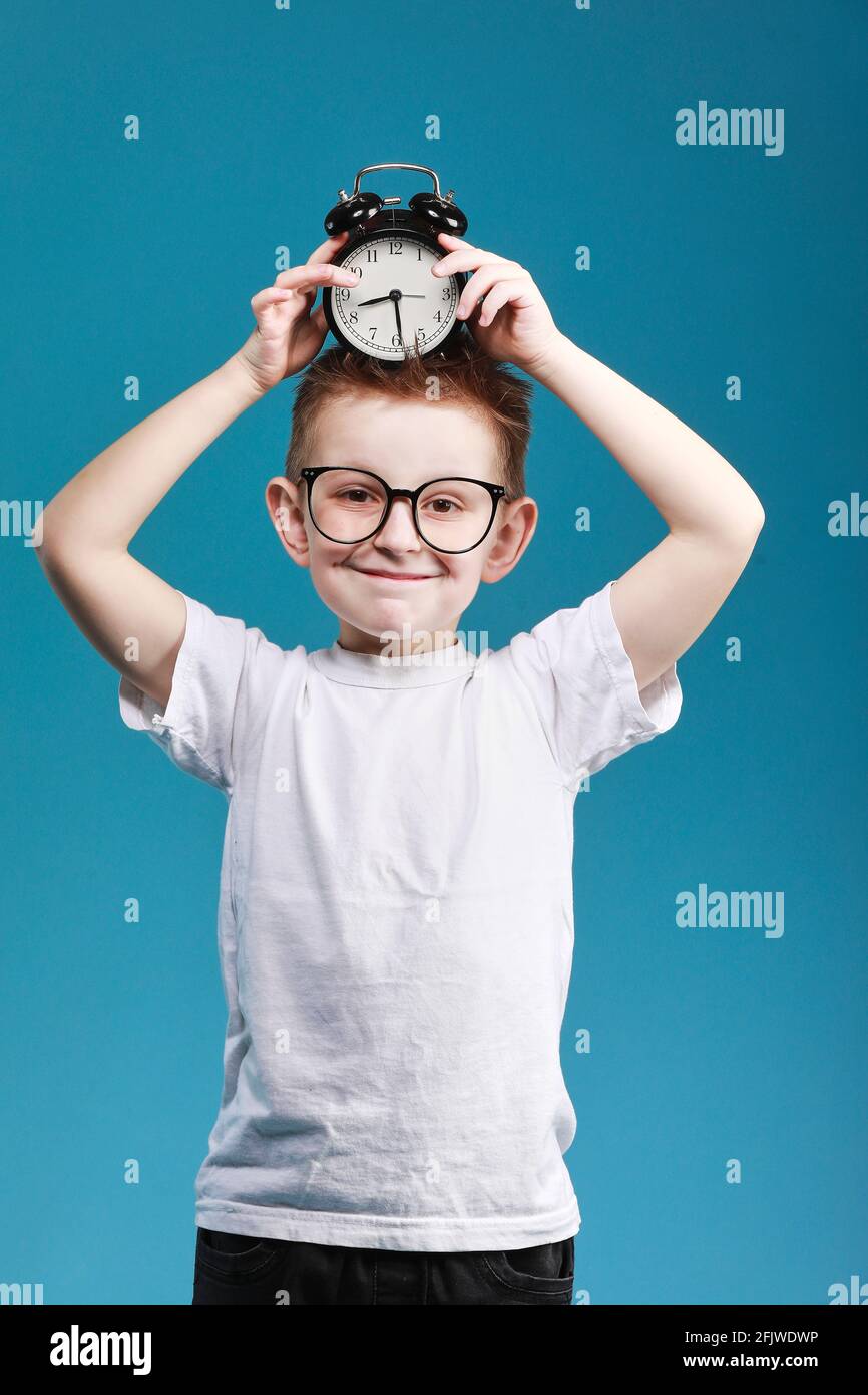 Time management. Morning. little boy with alarm clock. Happy childhood ...