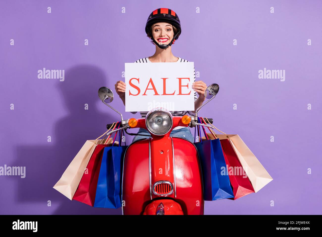 Photo of sweet moto lady dressed striped clothes red helmet sitting ...