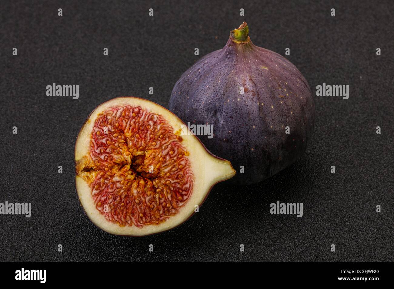 Sweet purple slice of fig fruit Stock Photo - Alamy