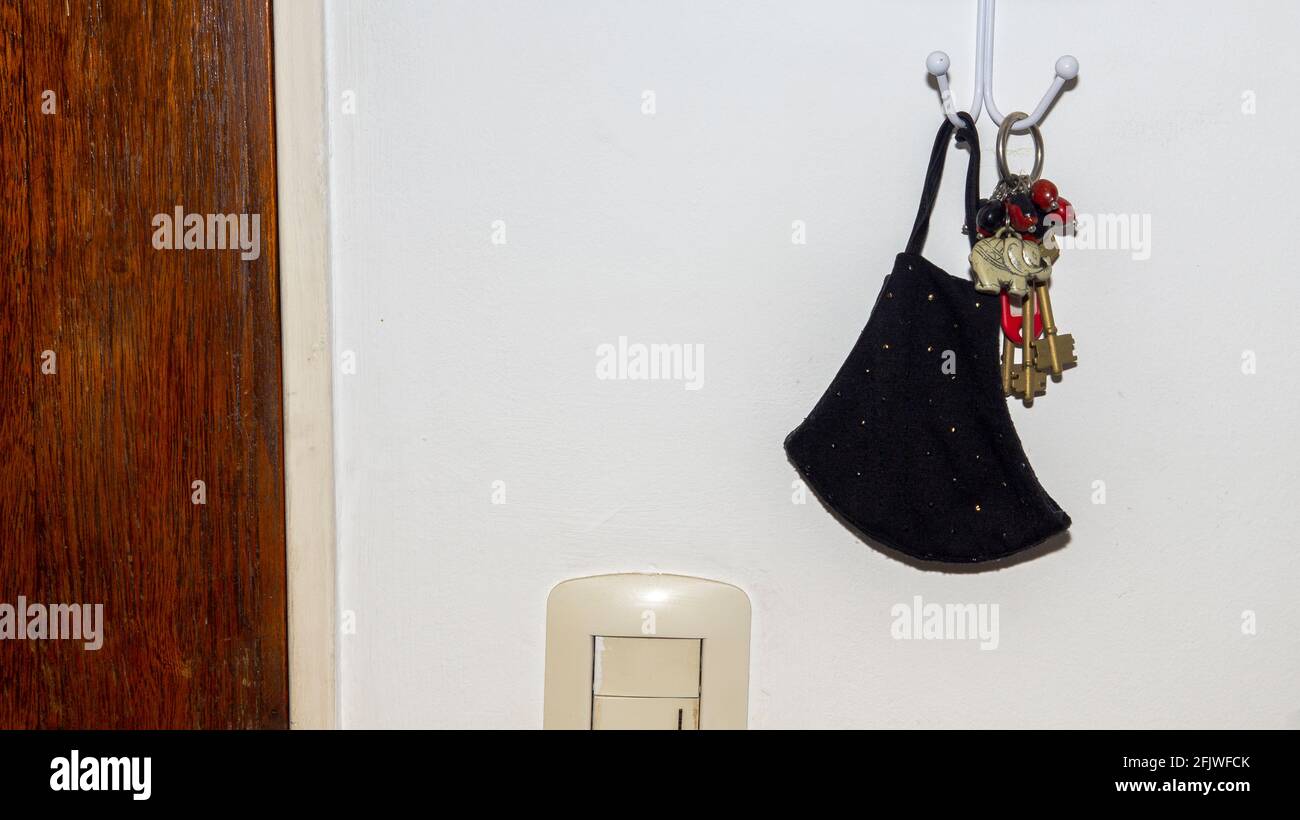 new normal concept. Face mask hanging from a hook next to the house ...
