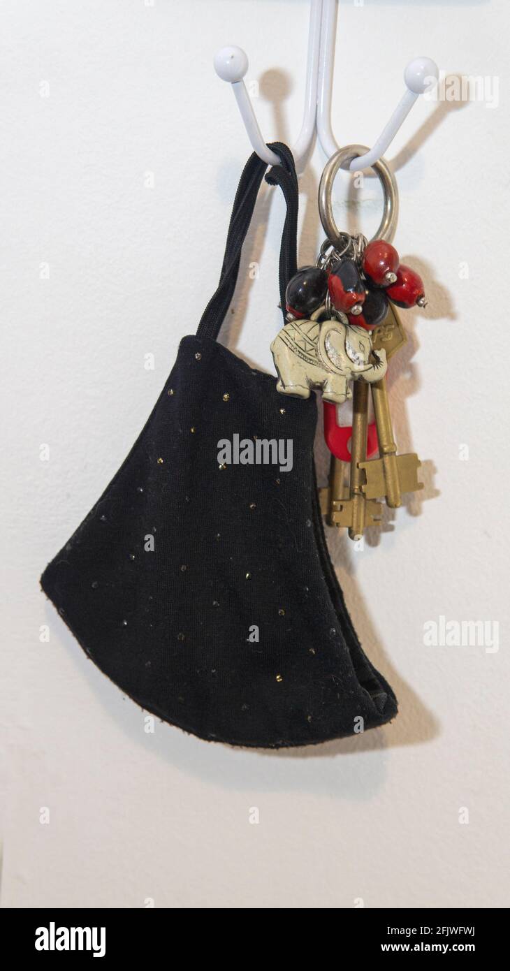 new normal concept. Face mask hanging from a hook next to the house ...