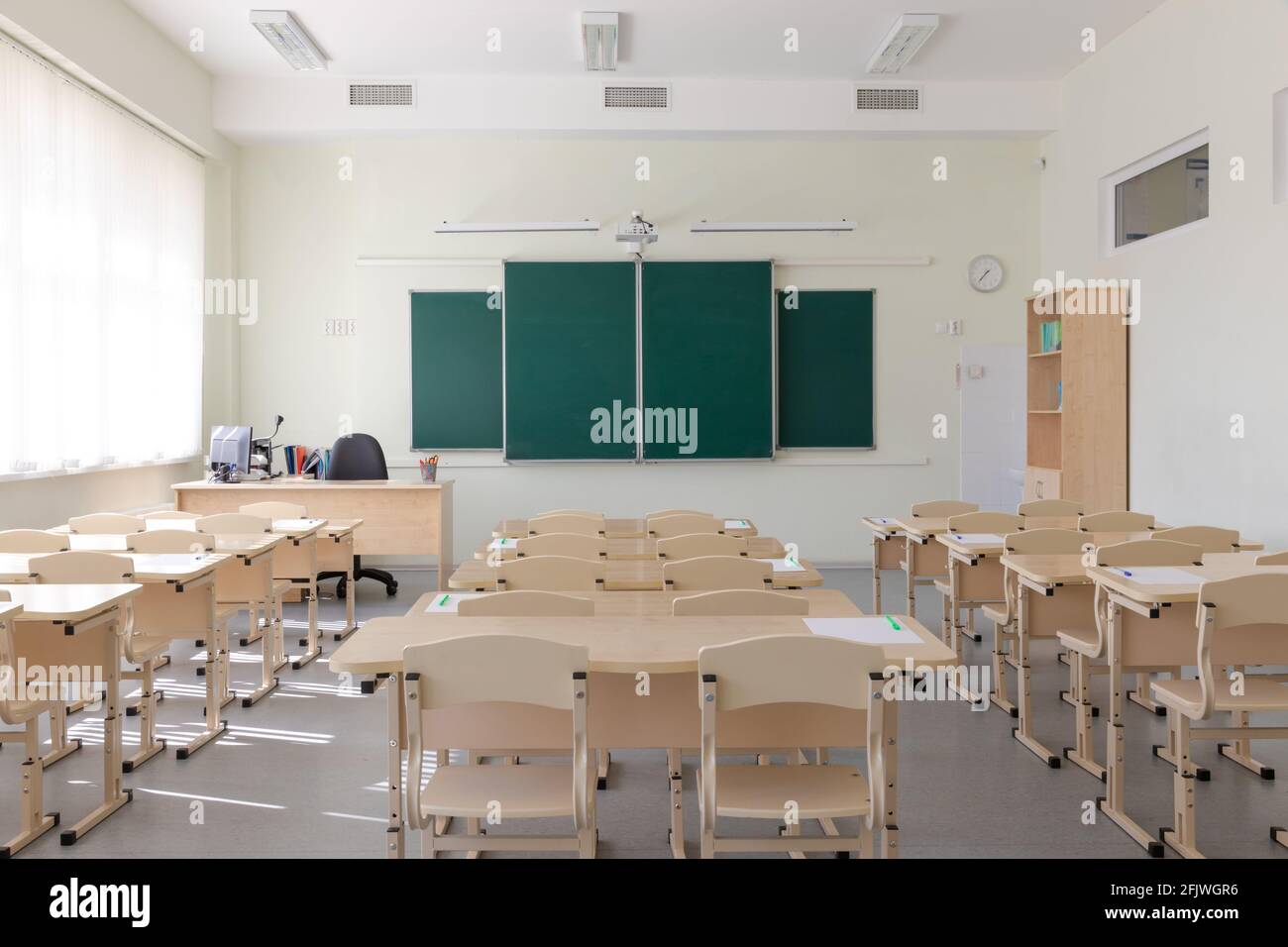 empty school class before final exams. sheets with handles are laid out ...