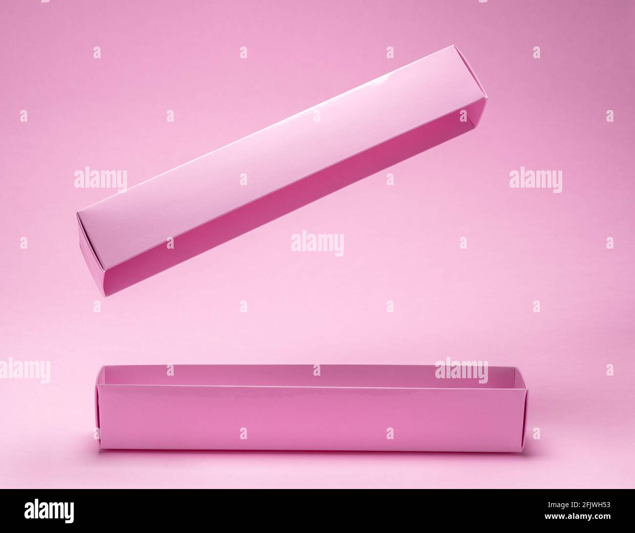 Empty open paper package box on pink background Stock Photo - Alamy