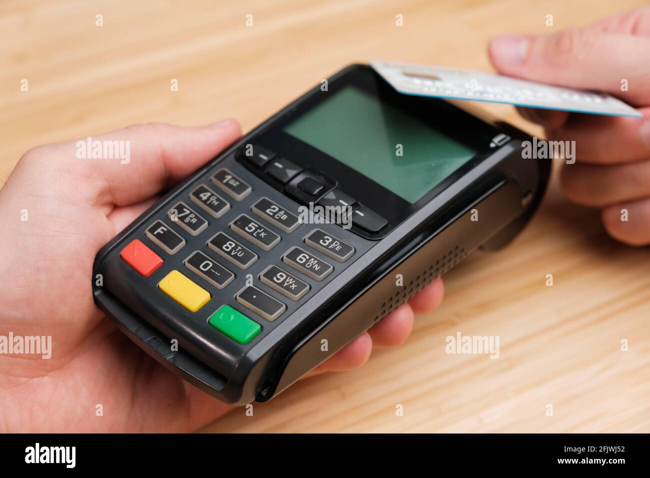 Close up man hand paying with contactless credit card with NFC ...