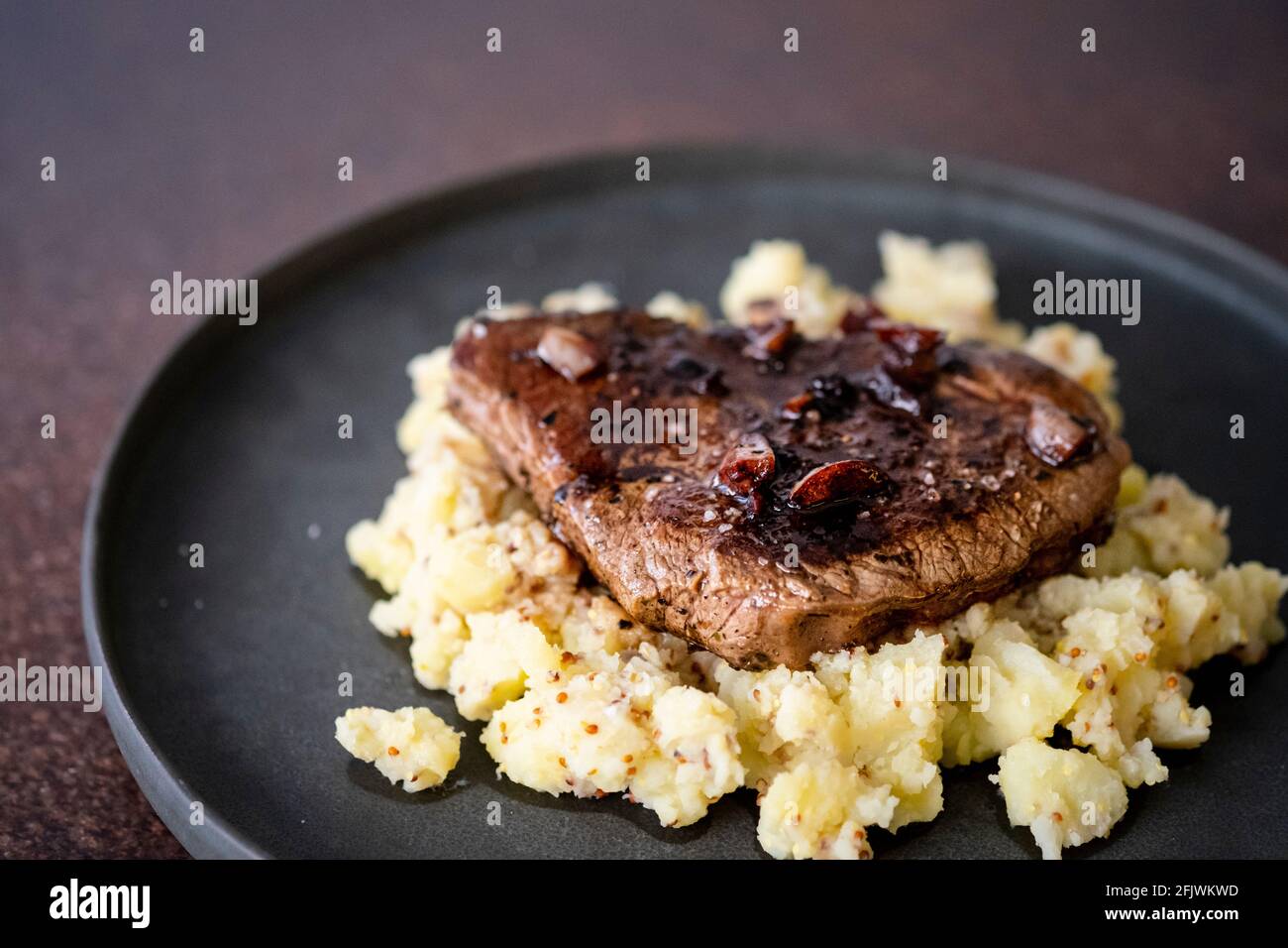Beef steak with garlic and potato purée with mustard Stock Photo - Alamy