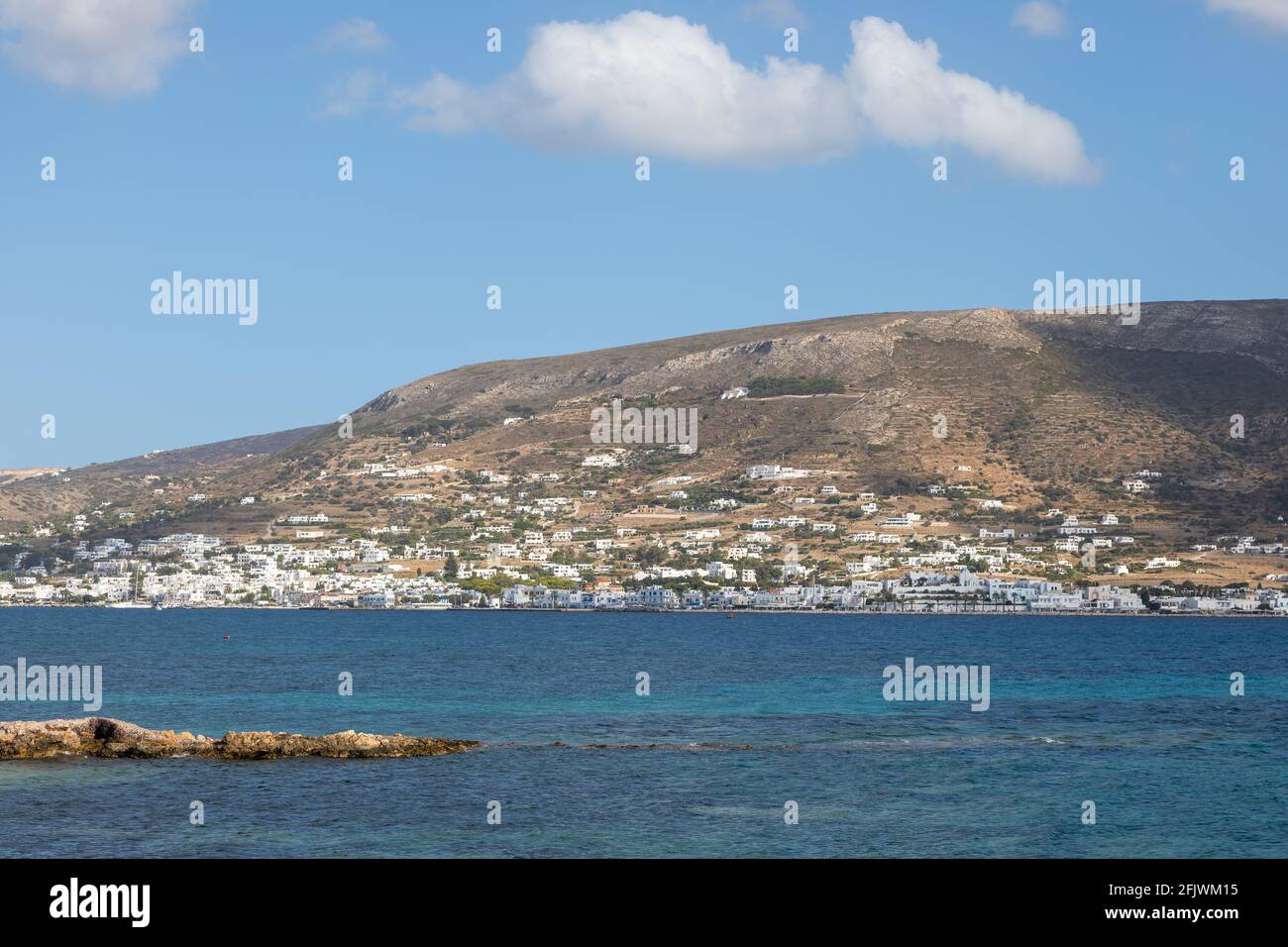 Rocky coast of the island of Paros. A white, traditional building in ...