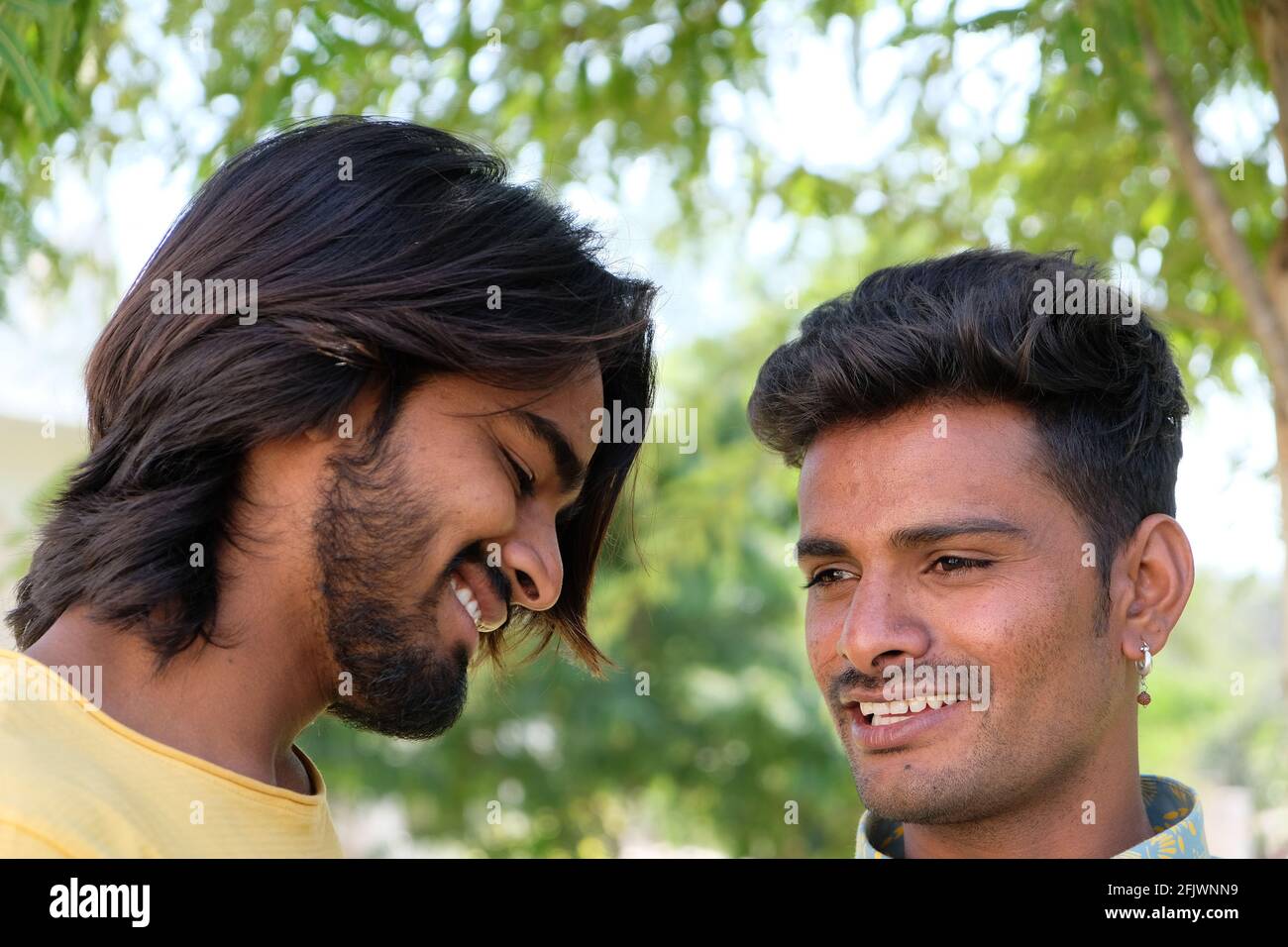 Portrait of two happy Indian males in the park Stock Photo - Alamy