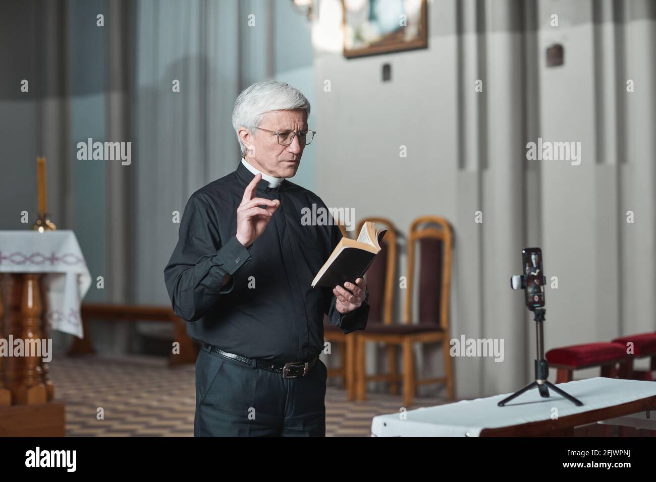 Priest reading bible hi-res stock photography and images - Alamy