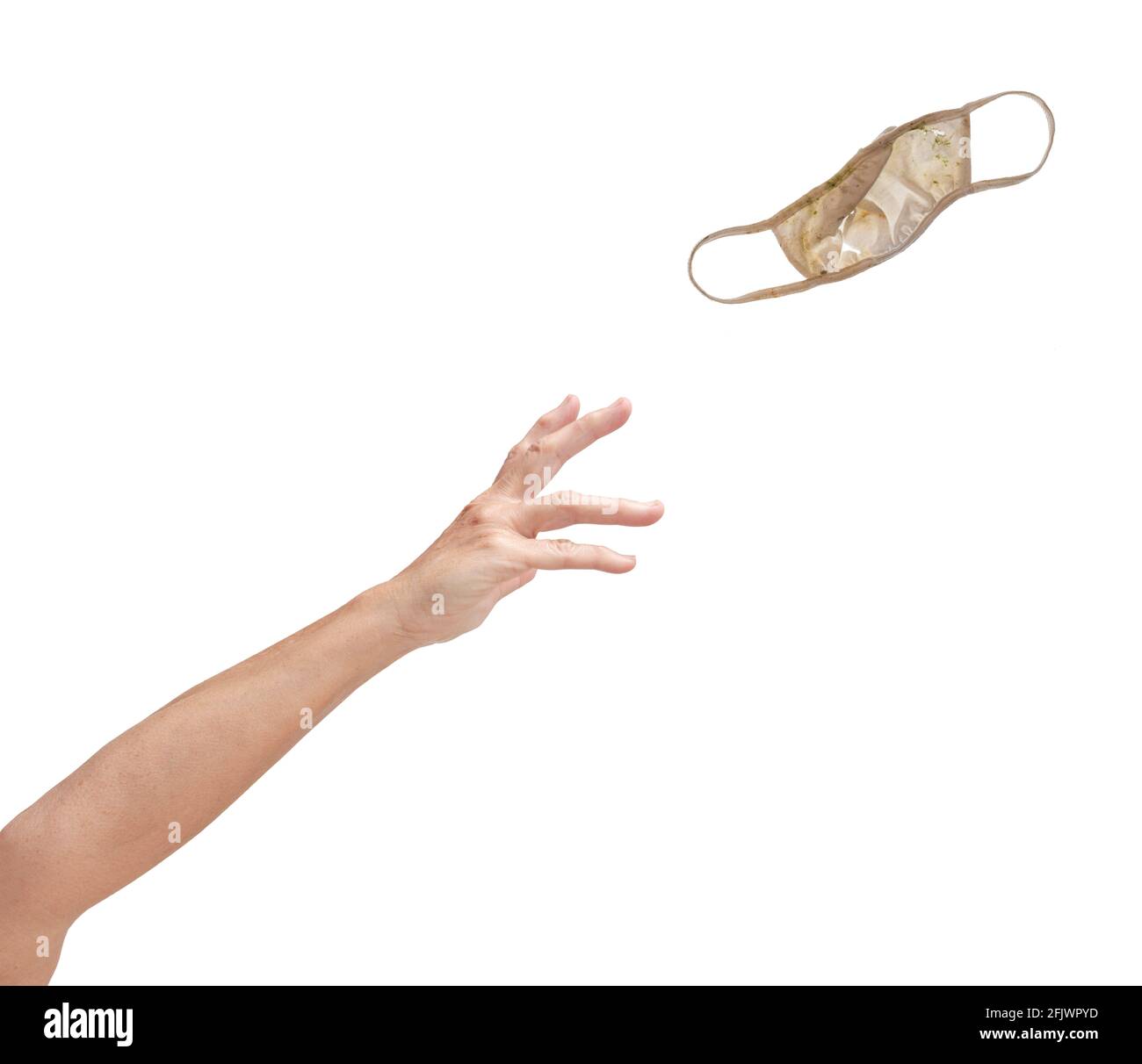 Hand and arm throwing away soiled covid face mask, isolated on white ...