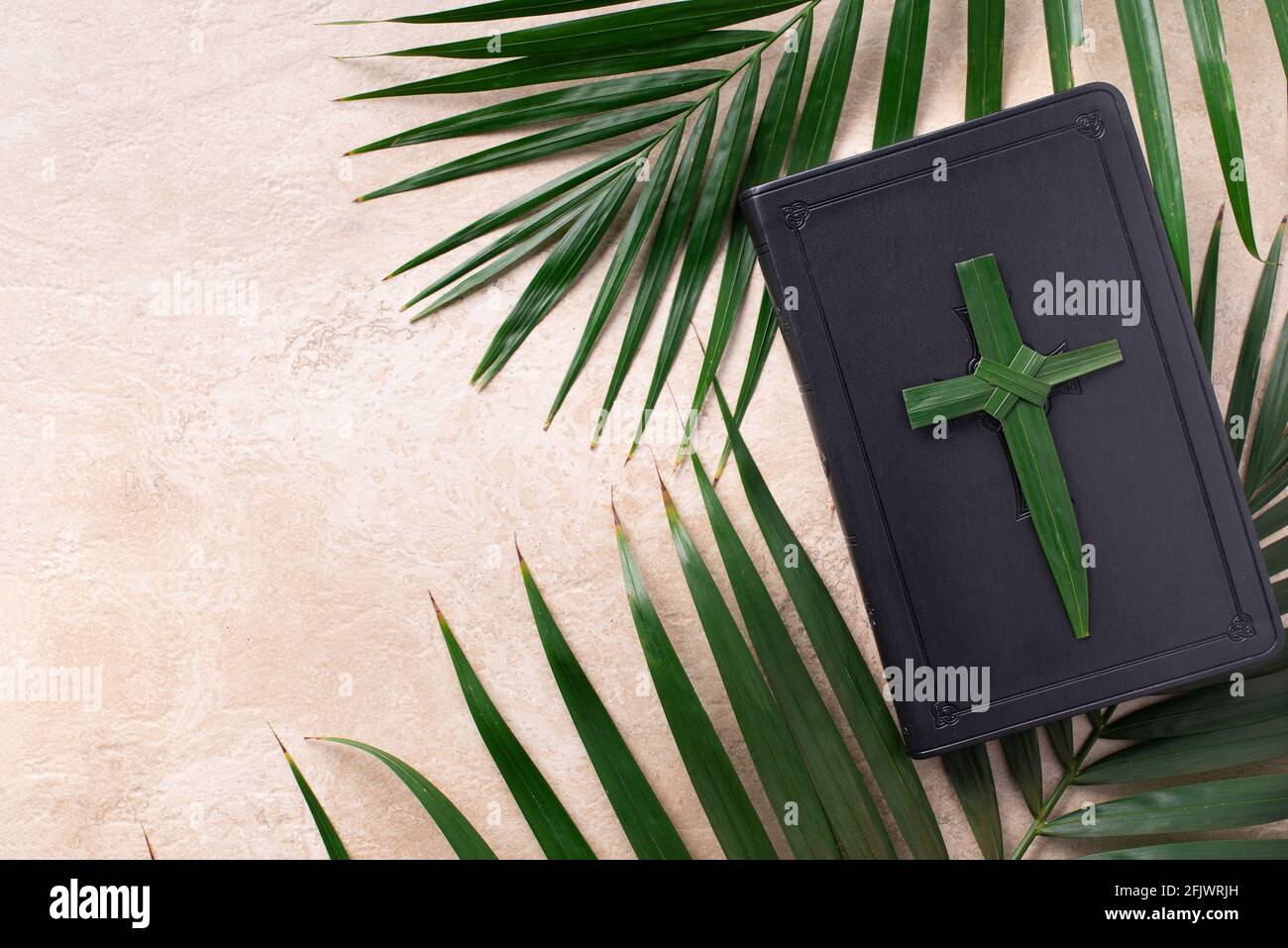 Palm Sunday concept. Palm cross on open Holy Bible and palm leaves ...