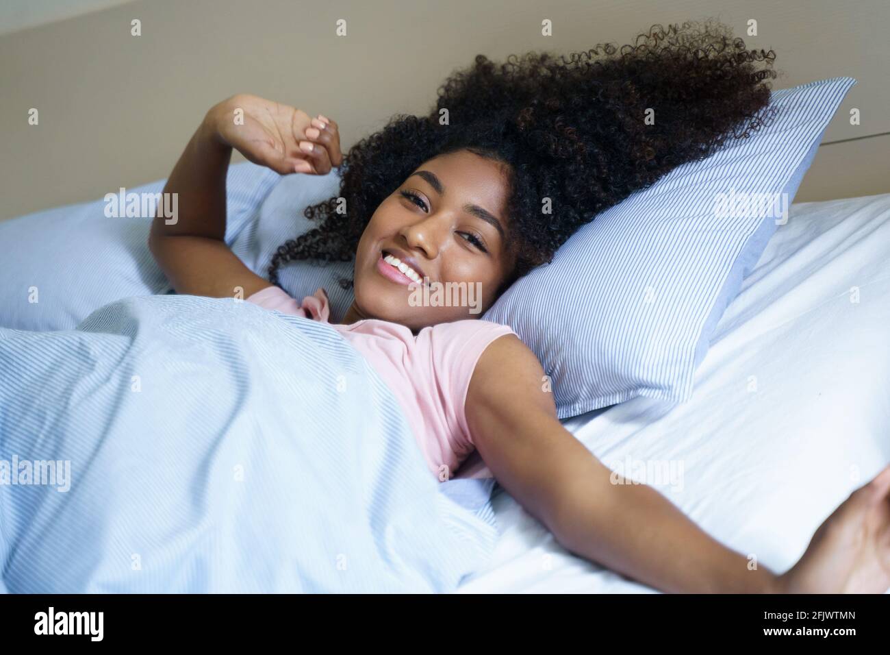African american girl waking up in bed hi-res stock photography and ...