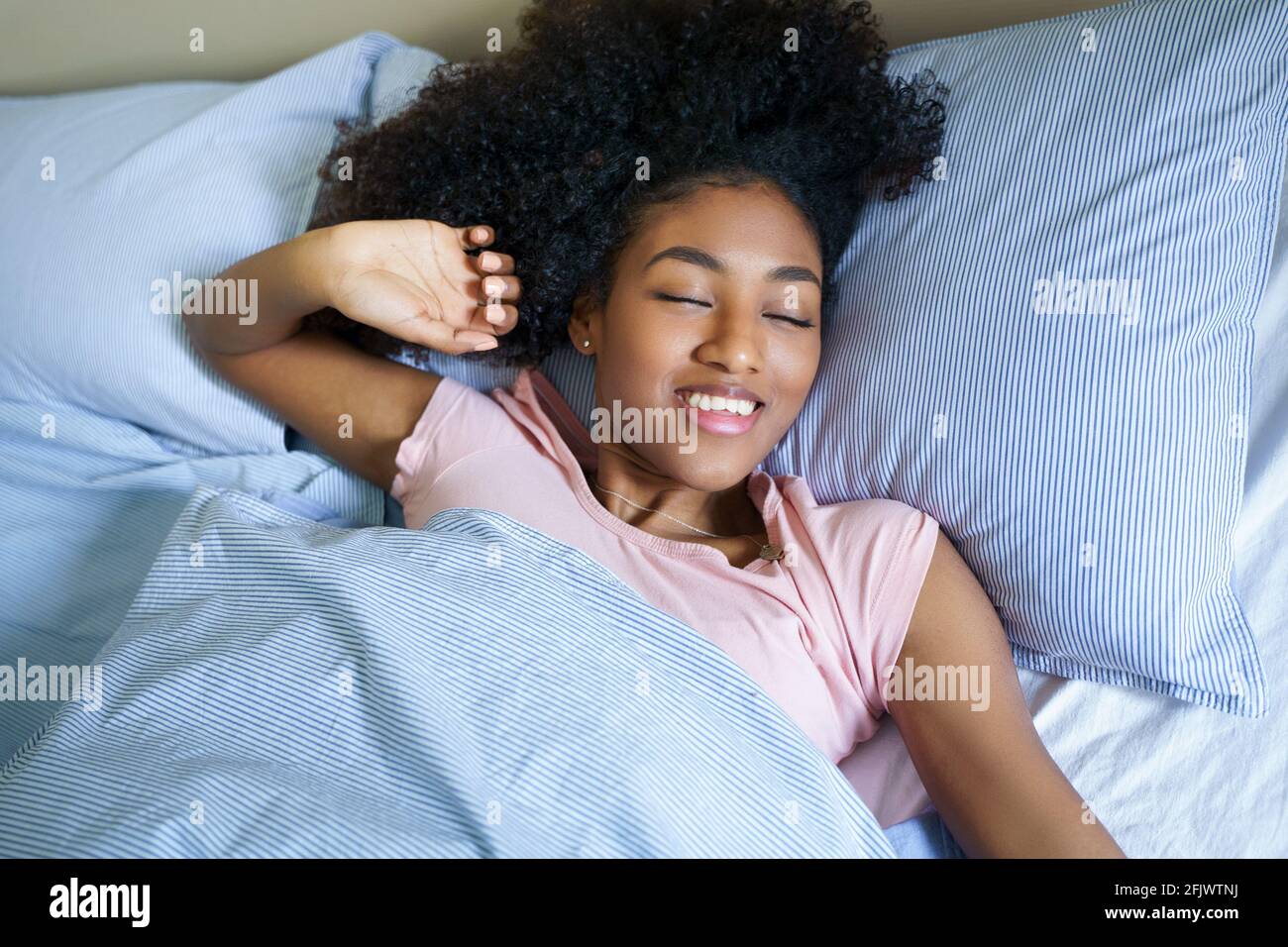 African girl waking up in bed hi-res stock photography and images - Alamy