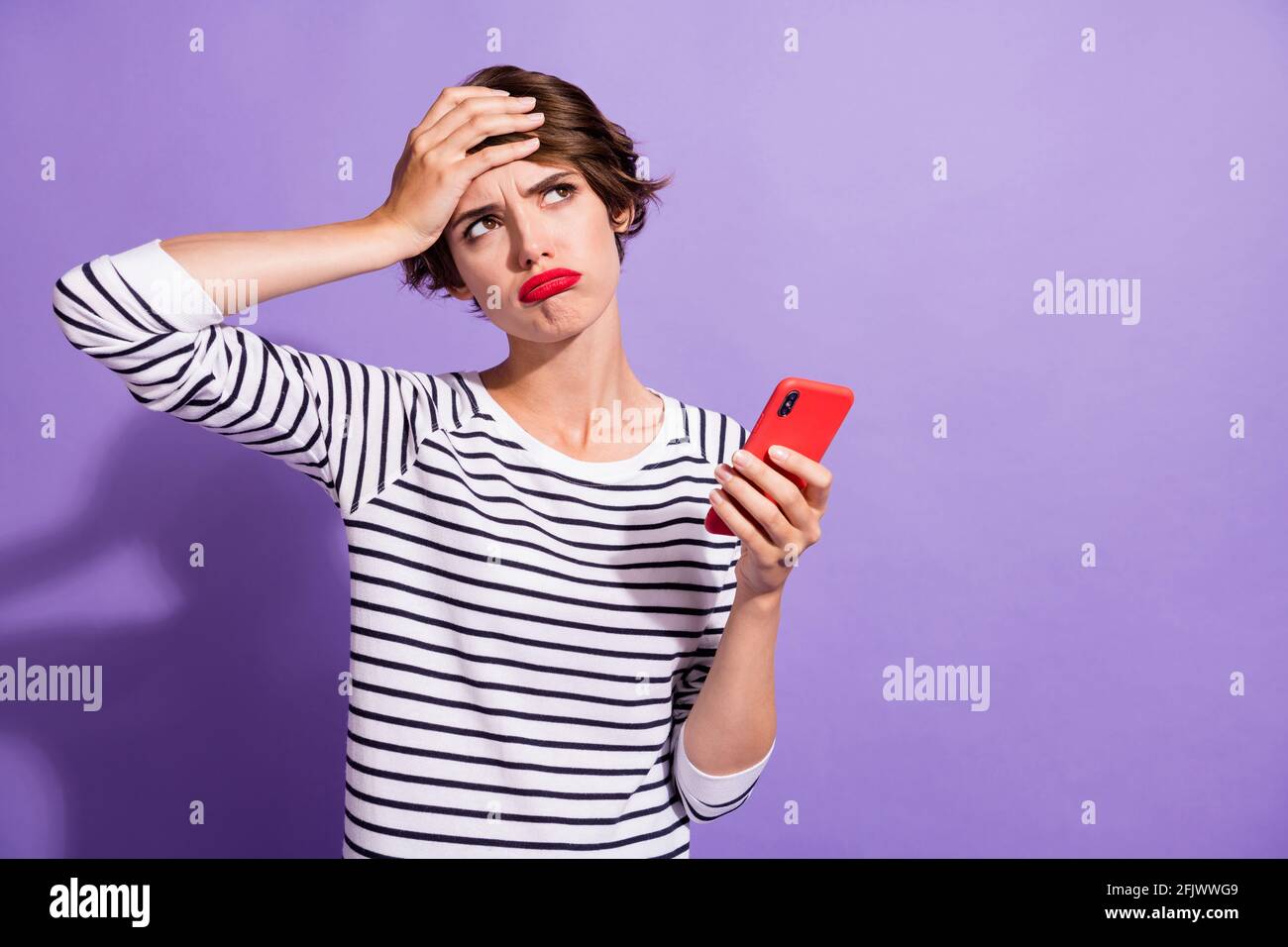 Photo of troubled upset girl hold cellphone palm brow look empty space ...
