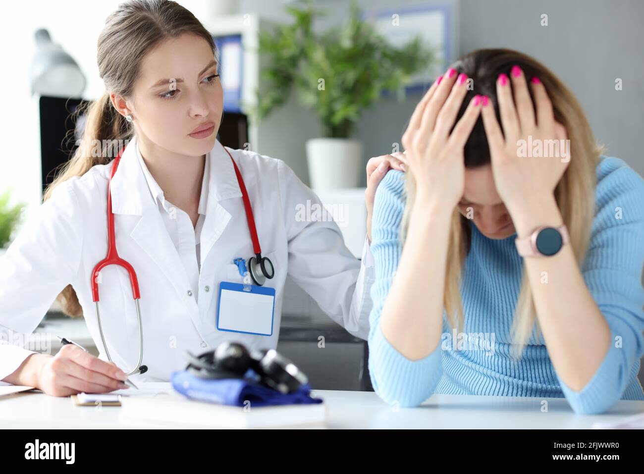 Doctor calms an upset woman after medical examination Stock Photo - Alamy