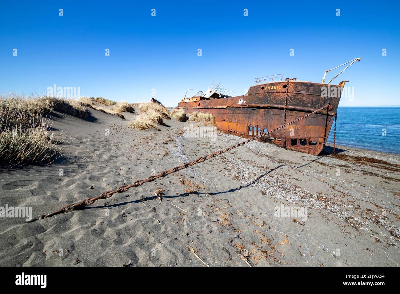 Wreckages, abandoned rusty stranded boat on San Gregorio beach in the ...