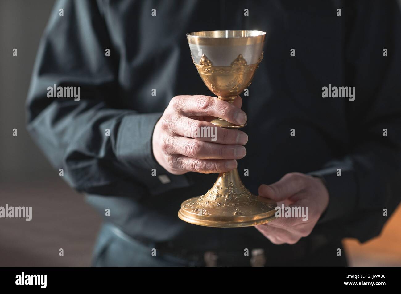 Close-up of senior priest holding the cup in the church Stock Photo - Alamy