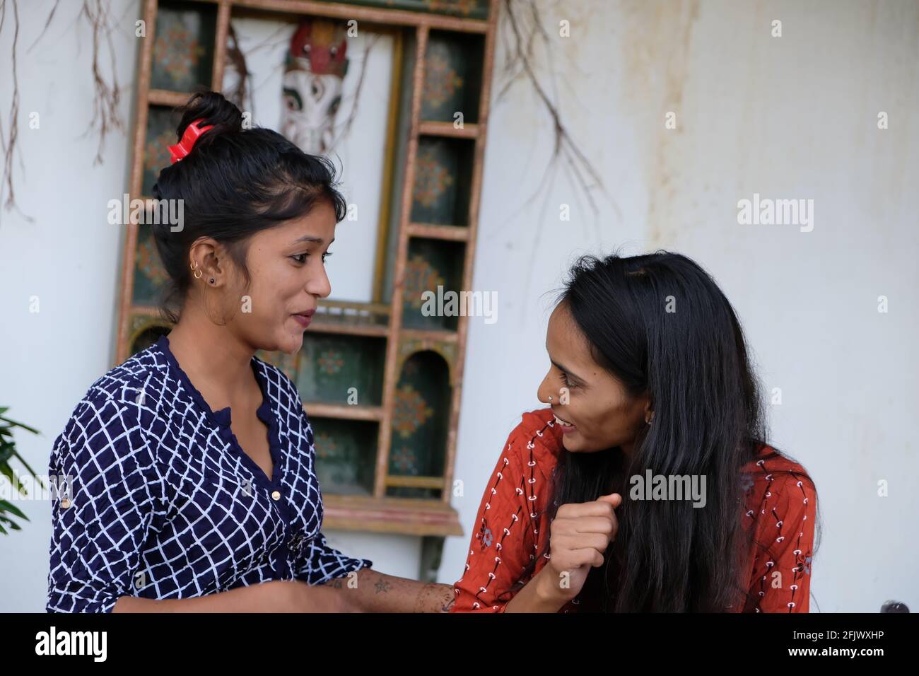Young Indian females having a nice conversation Stock Photo - Alamy