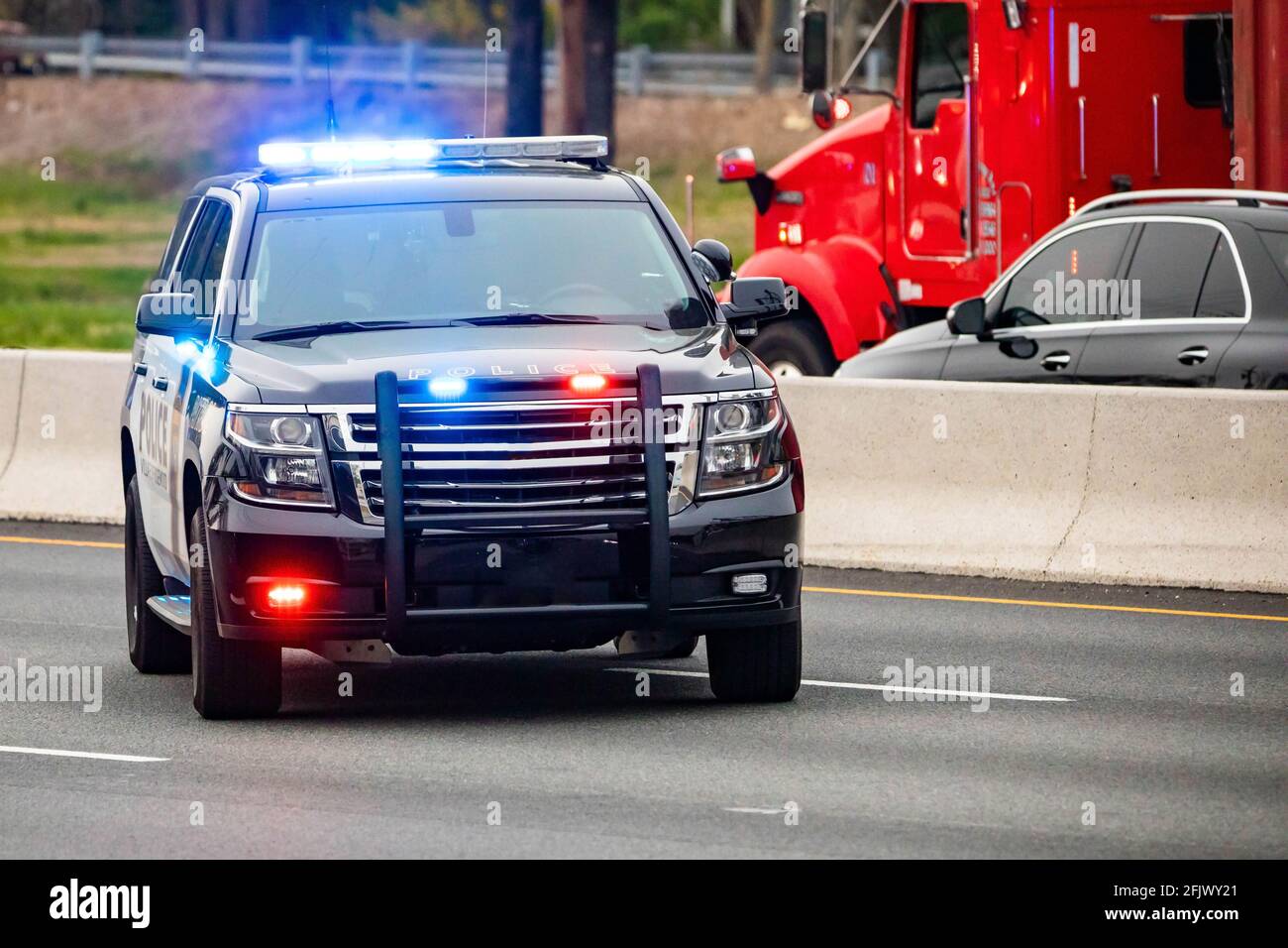 Road patrol police car on highway scene with emergency lights at day ...
