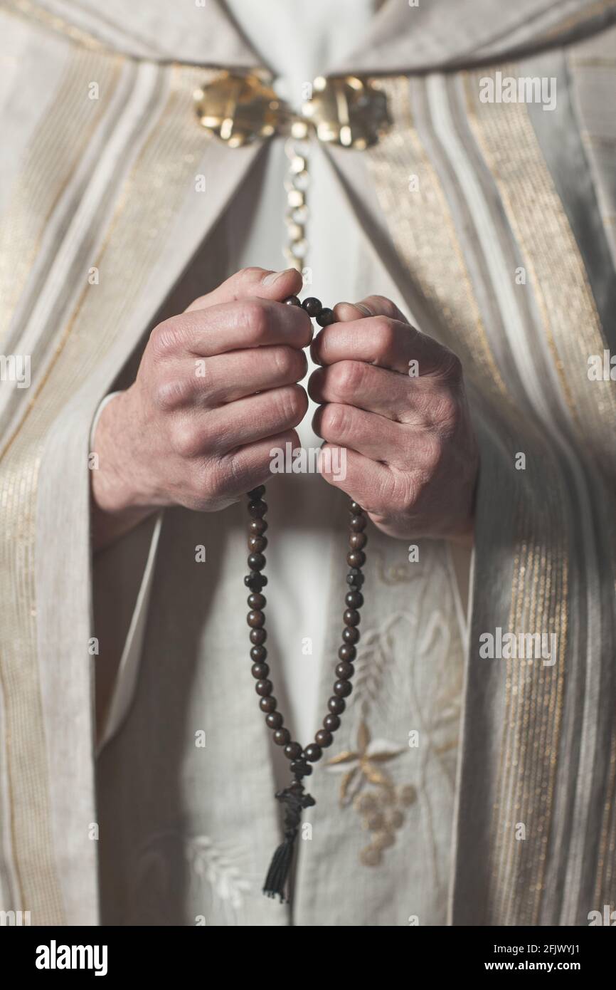 Close-up of priest in formal wear holding rosary beads Stock Photo - Alamy