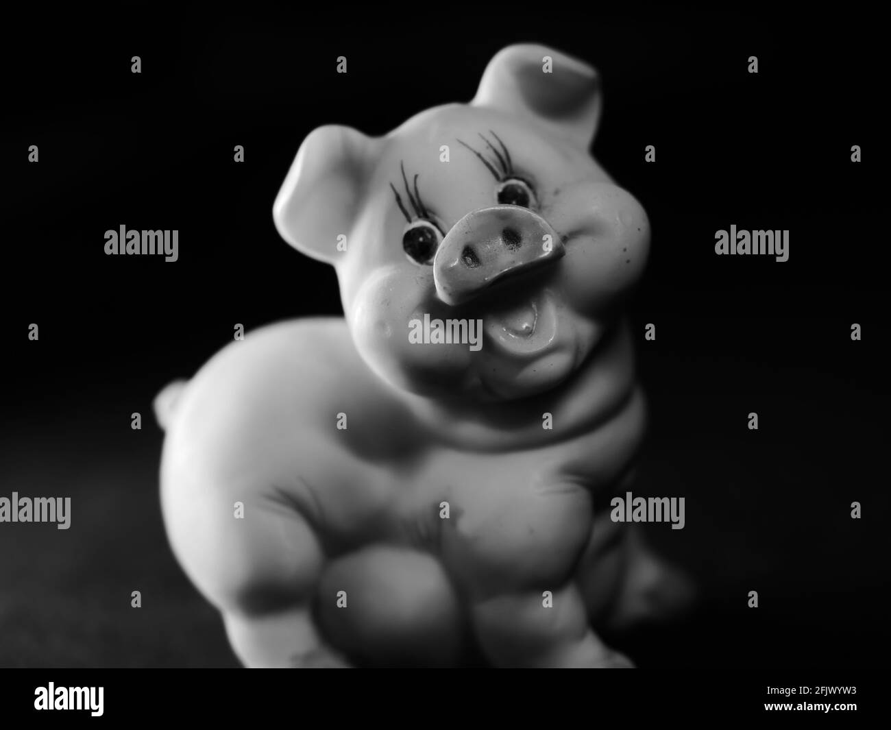 Grayscale shot of a plastic pig toy on a black background Stock Photo ...