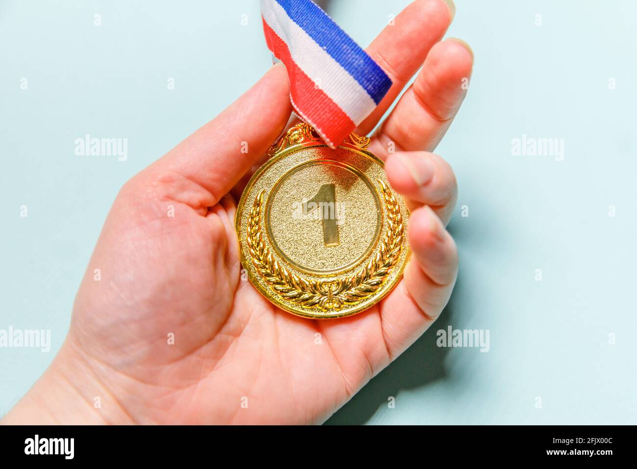 Simply flat lay design hand holding winner or champion gold trophy ...
