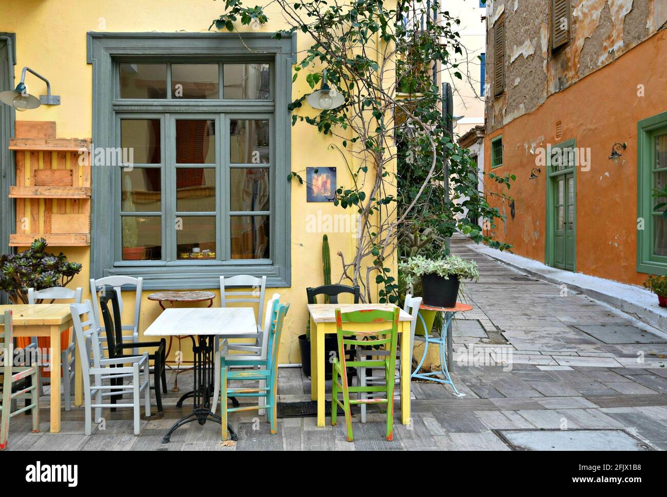 Traditional Greek taverna patio with colorful picturesque furniture in ...