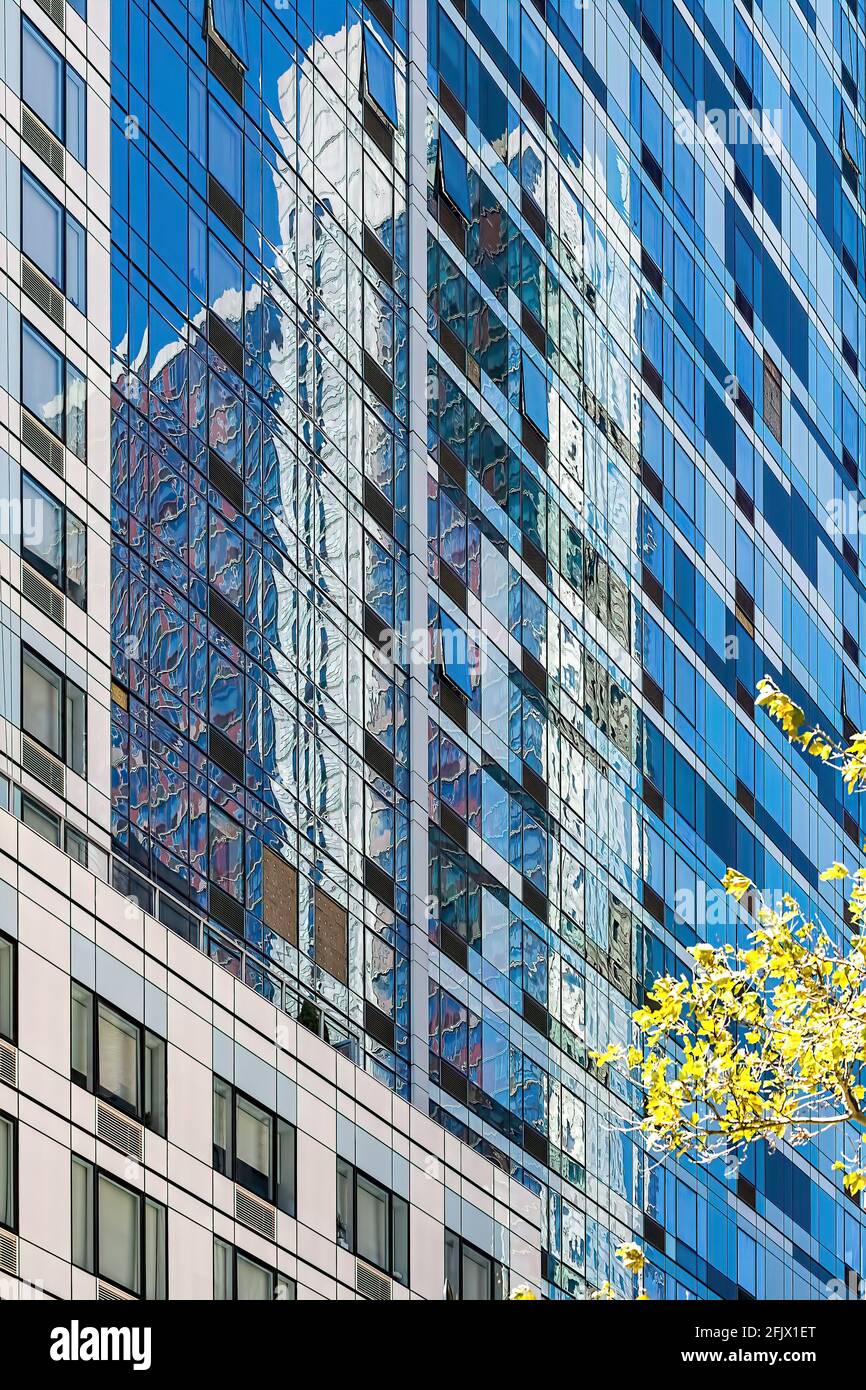 Glass facade of New York City skyscraper mirrors its surroundings Stock ...