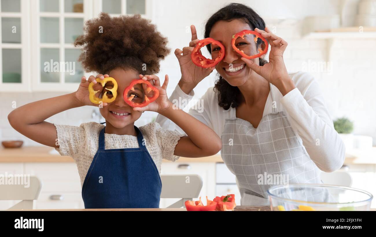 Happy excited mommy and daughter girl having fun while cooking Stock ...