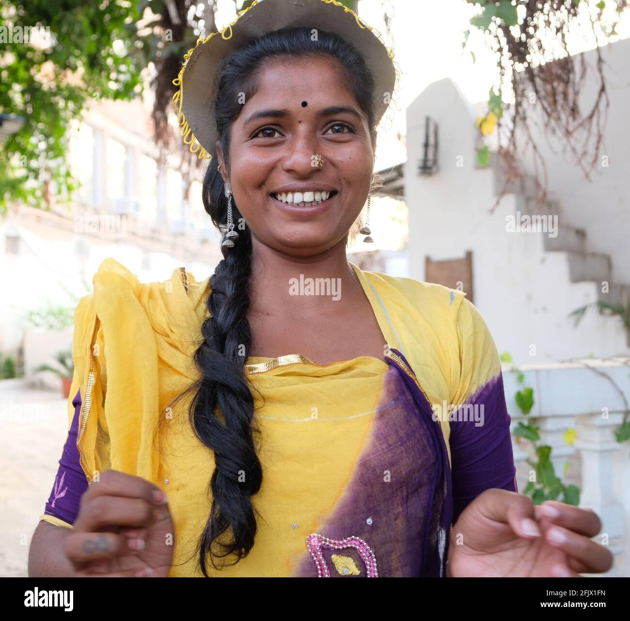 Portrait of a young Indian female wearing an orange party hat Stock ...