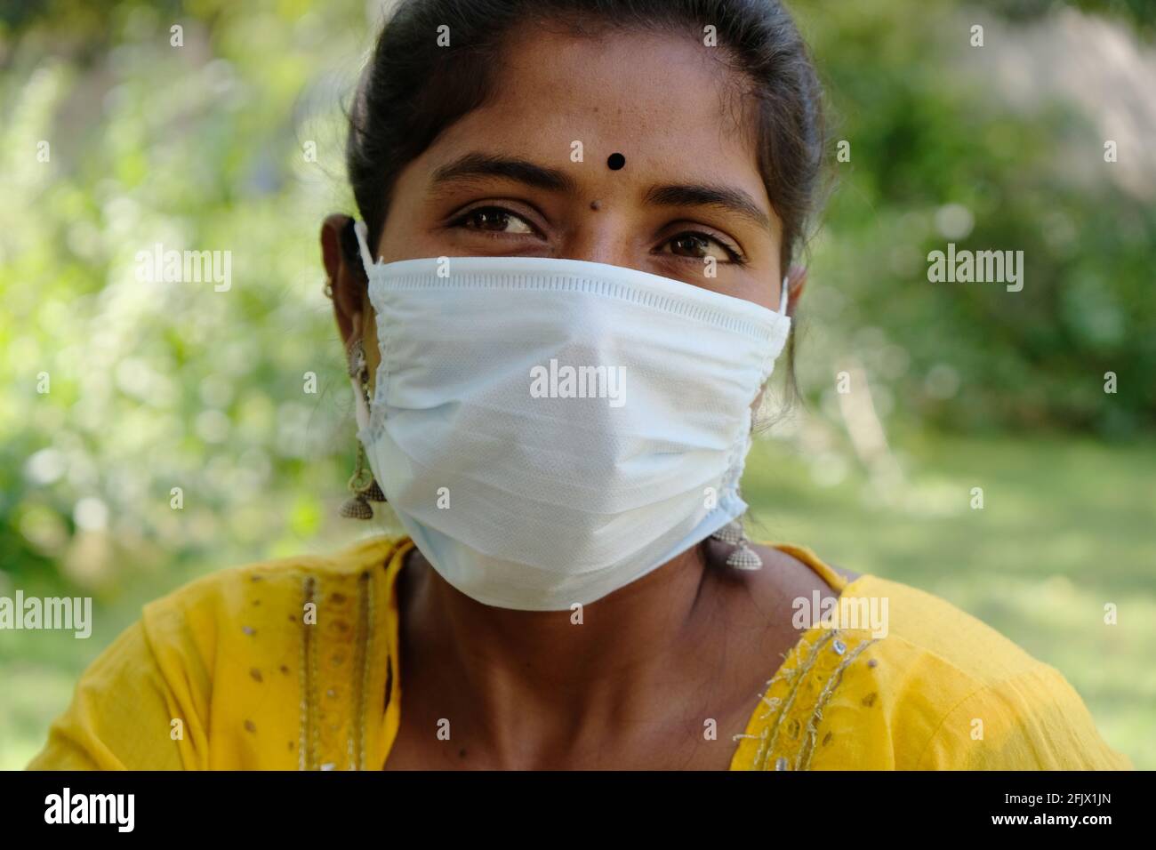 Portrait of a young Indian female with collected hair and a medical ...