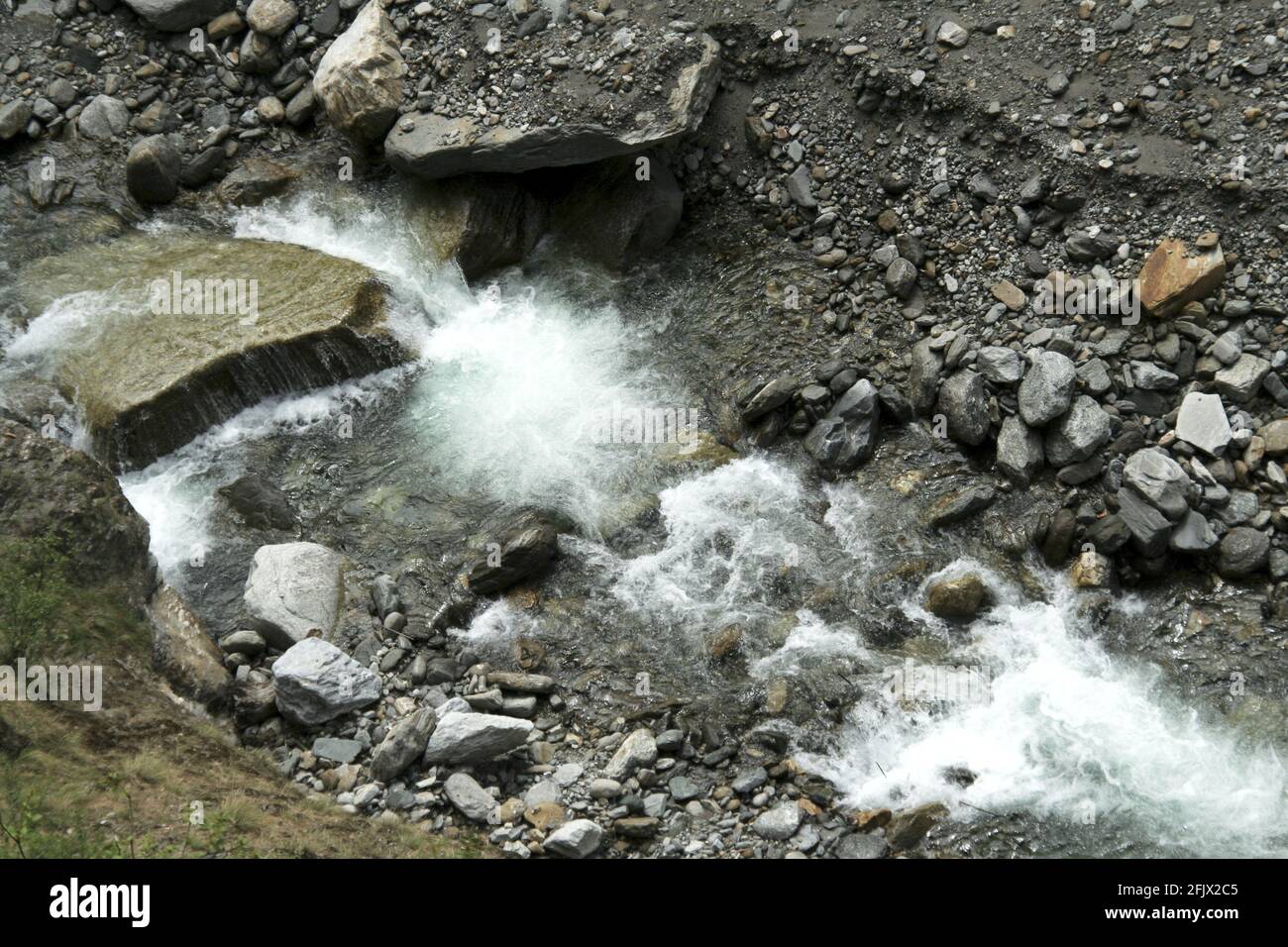 Water flowing through rocks and pebbles in a river Stock Photo - Alamy