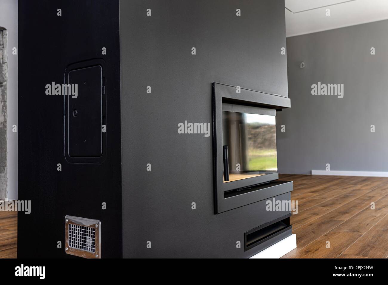 A modern fireplace with a closed combustion chamber standing in the ...