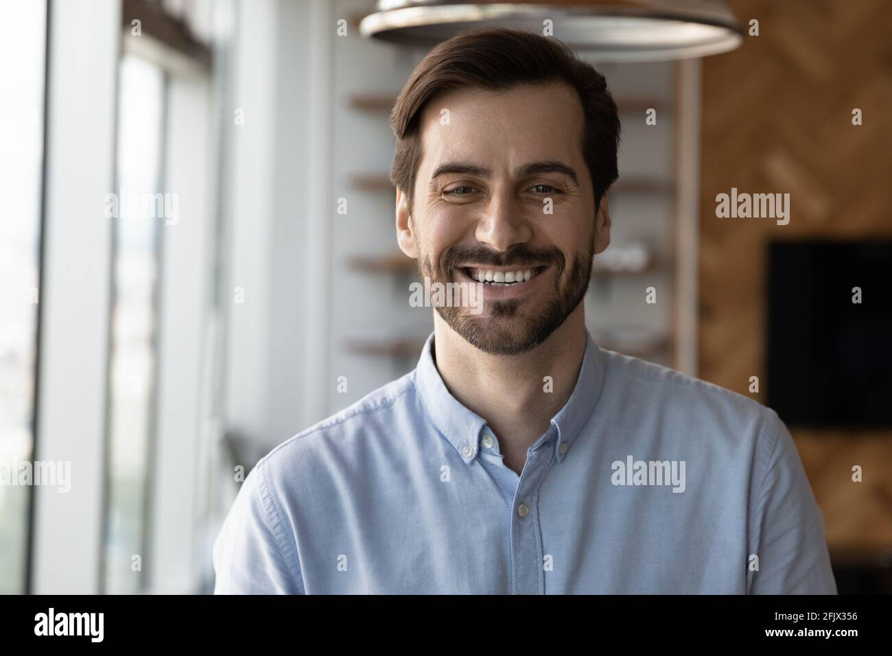 Headshot portrait of smiling man posing in office Stock Photo - Alamy