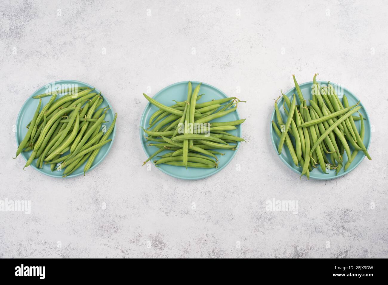 Green string beans on a textured background, empty space for text ...