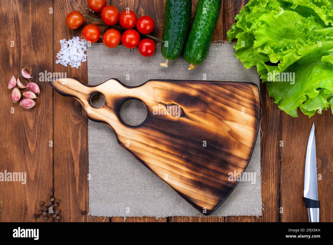 Cutting wooden board on a wooden table. Handmade chopping board. Fresh ...