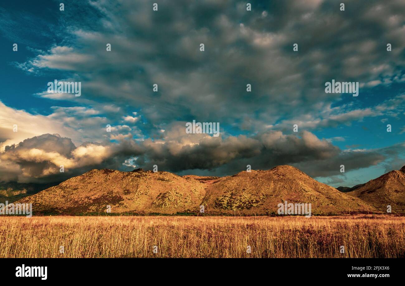 Distant mountains with cloudy deep blue skies Stock Photo - Alamy