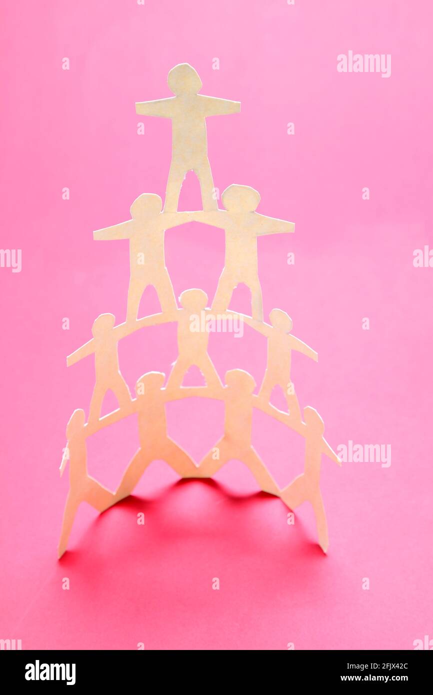 Human team pyramid supporting each other Stock Photo - Alamy