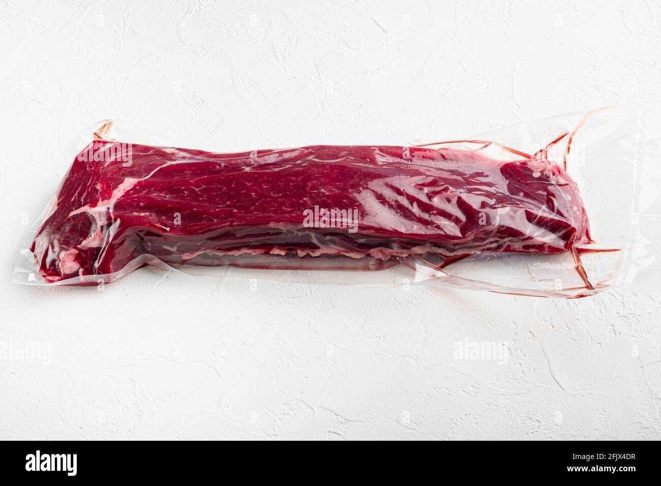 Fresh raw beef in vacuum-Packed filet mignon cut set, on white stone ...