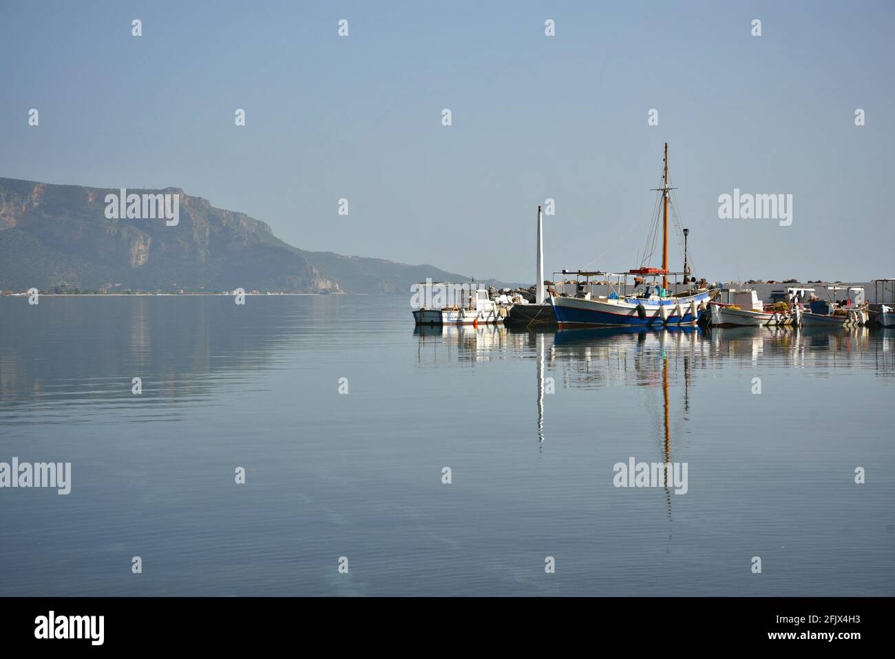 Landscape with the port view and the Greek fishing boats of Poulithra ...