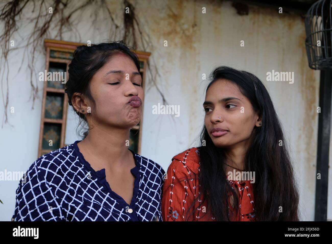Closeup shot of two South Asian female friends having a funny ...
