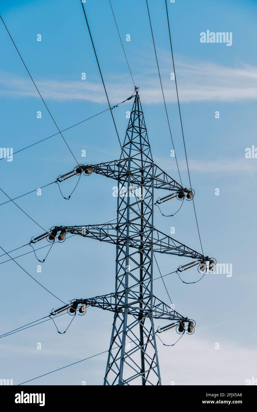 A low angle shot of overhead electric power lines with insulators Stock ...